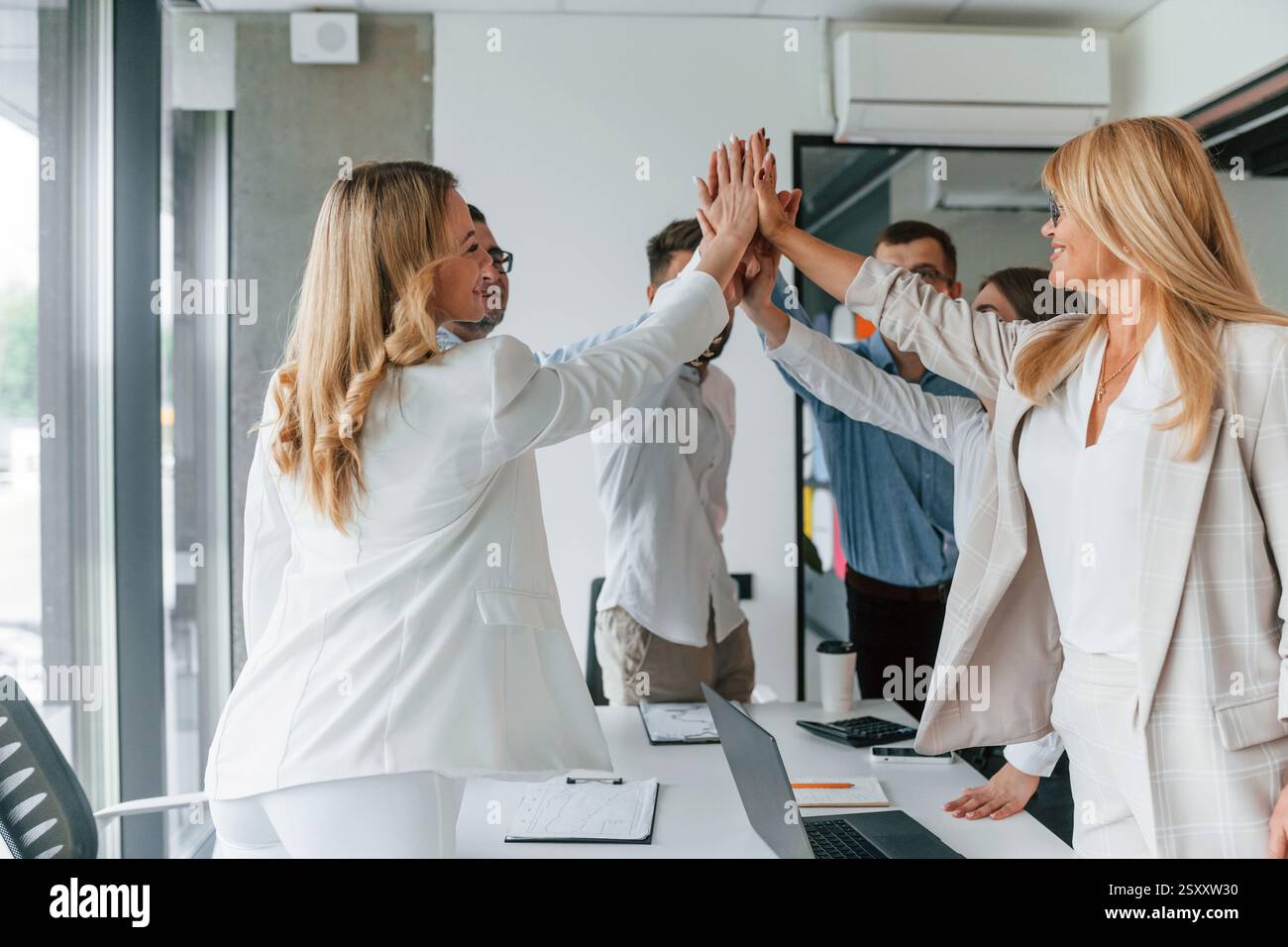 Doing high five. Successful agreement. Group of professional business ...