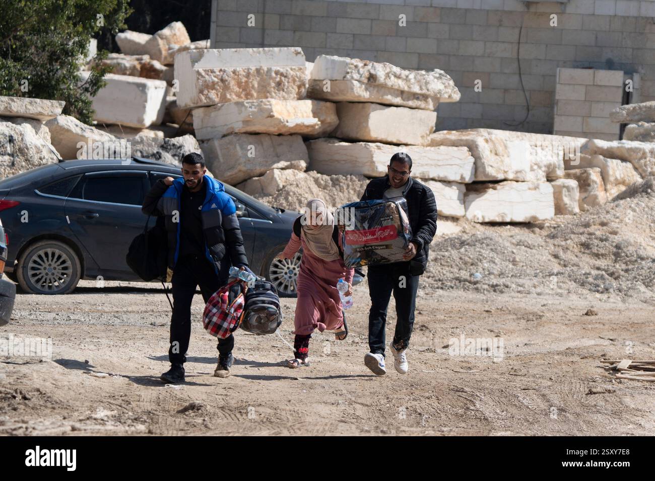 Tulkarm, Palestinian Territories. 26th Feb, 2025. Palestinians carry ...