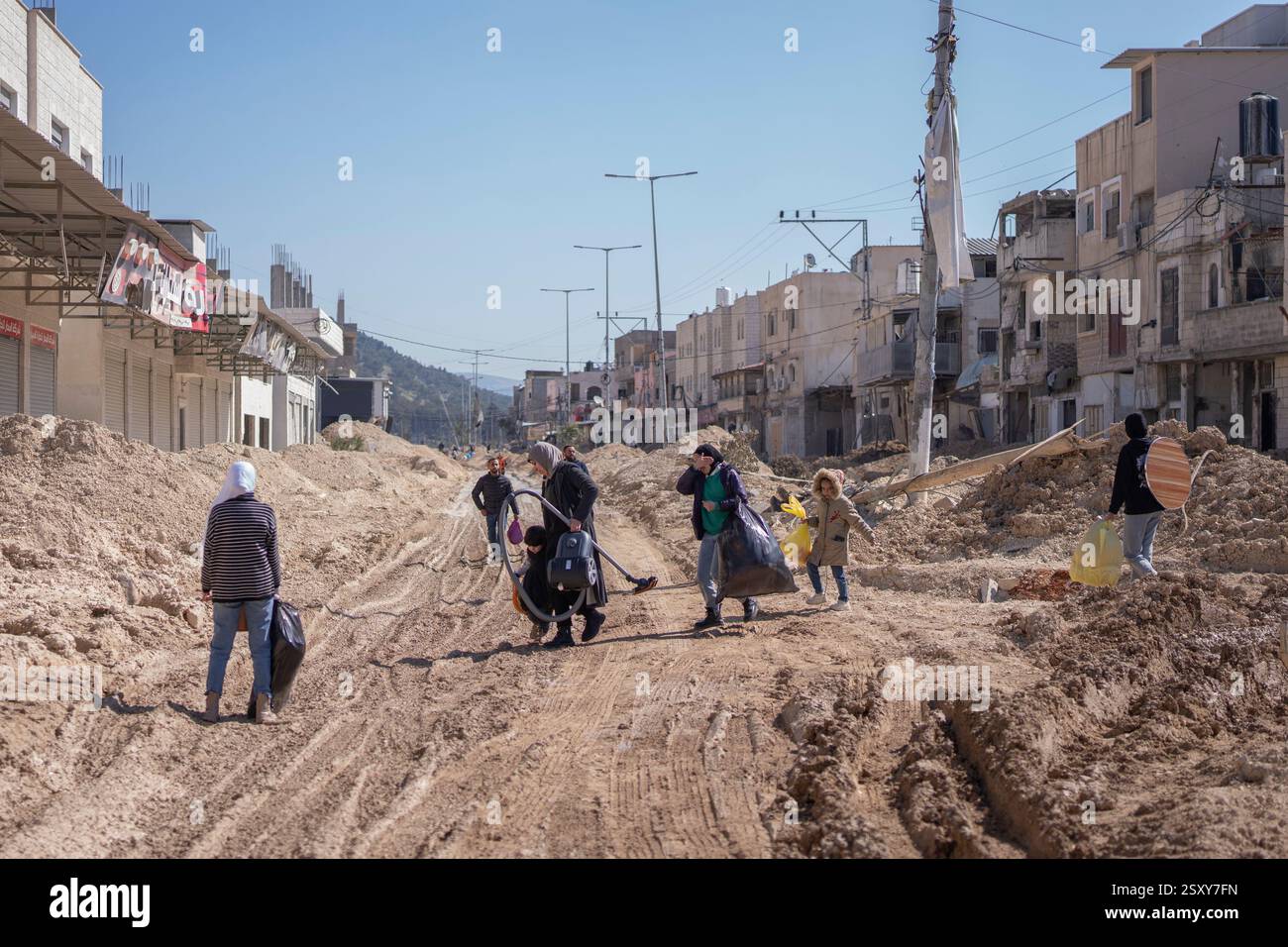 Tulkarm, Palestinian Territories. 26th Feb, 2025. Palestinians carry ...