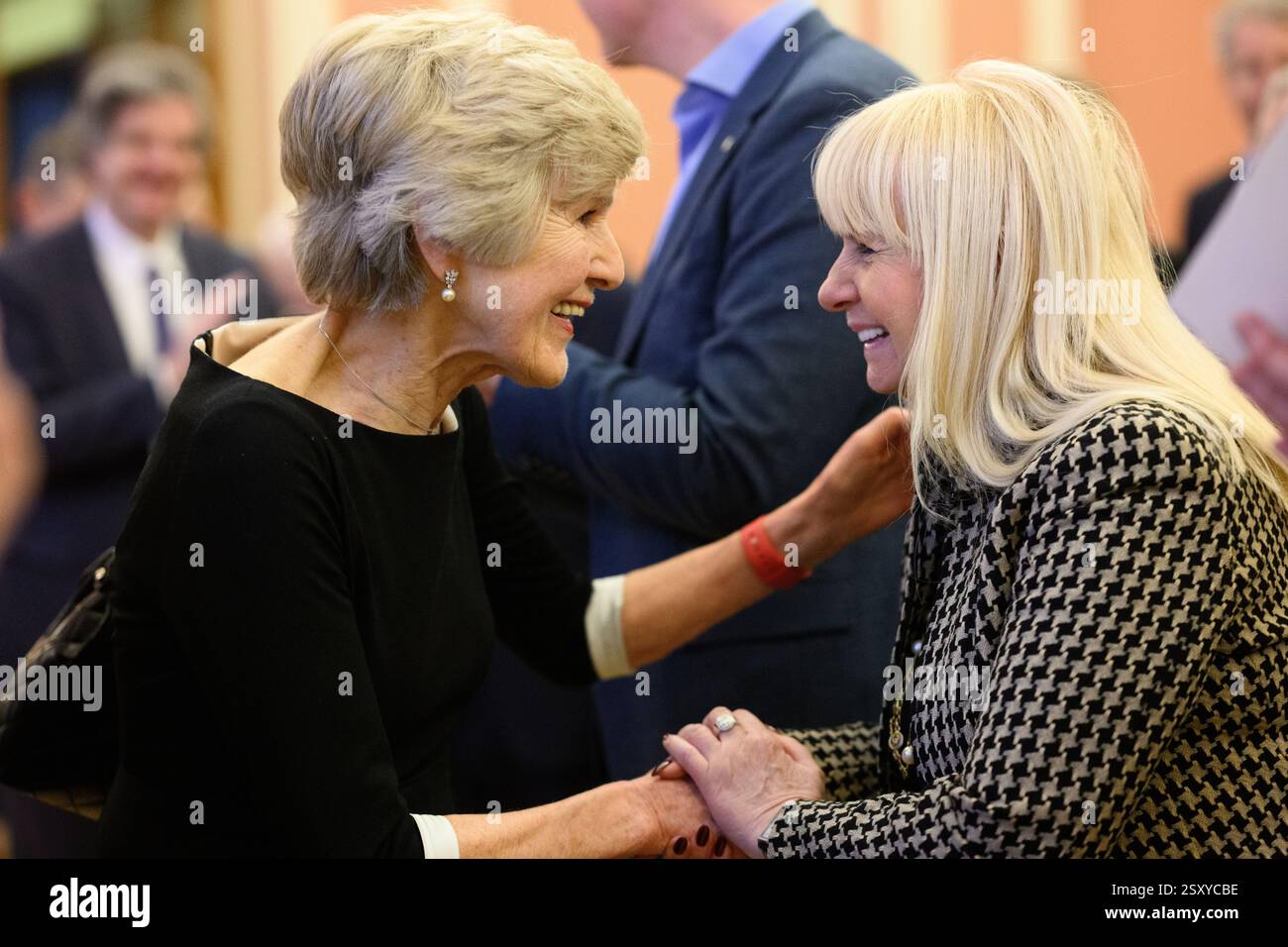 26 February 2025, Berlin: Friede Springer (l) greets Iris Spranger (SPD ...