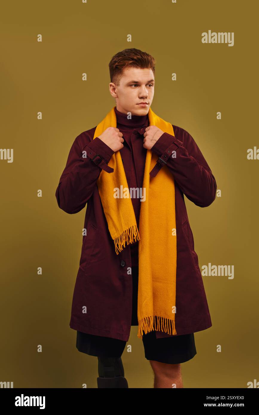 A young man with a prosthetic leg displays fashionable clothing and ...