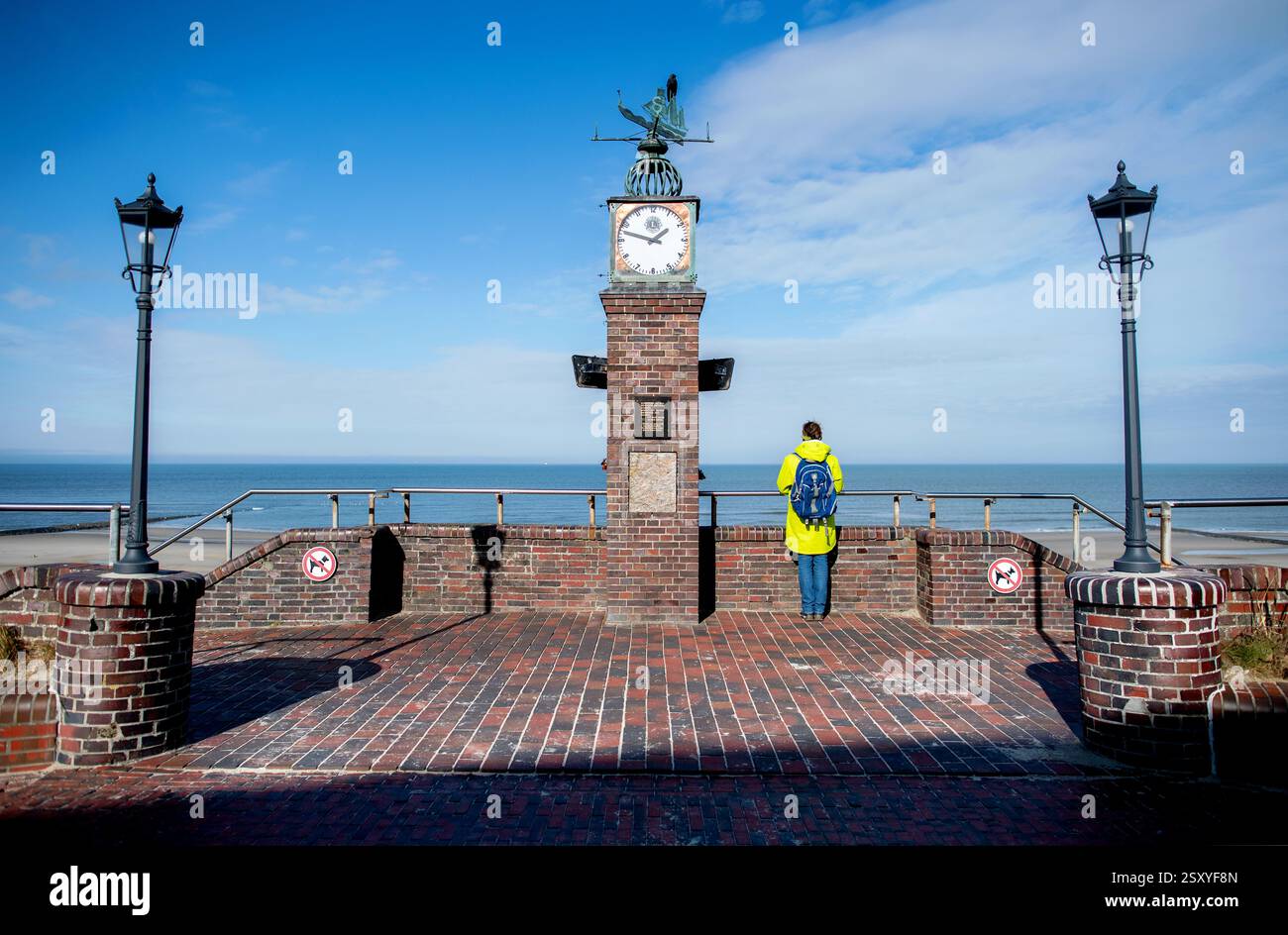 Wangerooge, Germany. 26th Feb, 2025. A woman stands by the historic ...