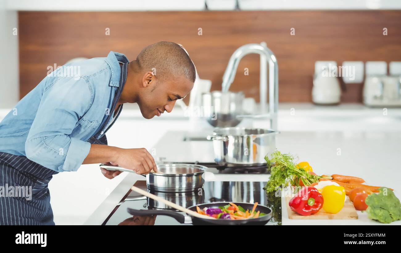 Man cooking in modern kitchen hi-res stock photography and images - Alamy