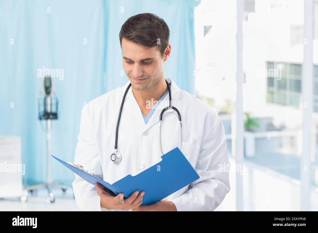 Medical staff reviewing clipboard in hi-res stock photography and ...