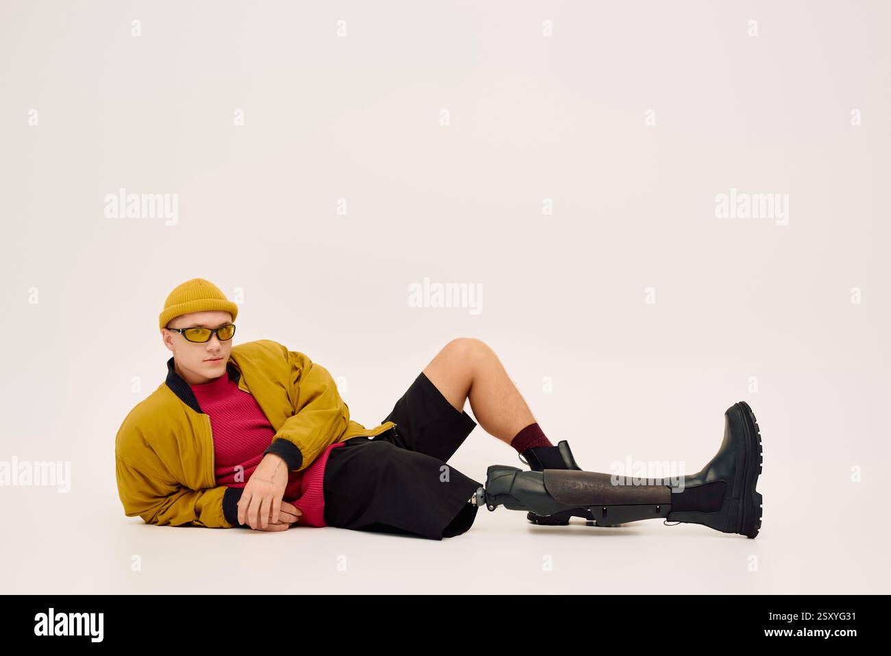 Handsome young man lounges effortlessly in fashionable attire ...
