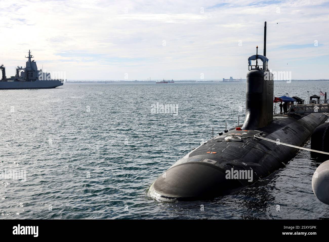U.S. Navy officers stand guard aboard the Virginia-class fast-attack ...