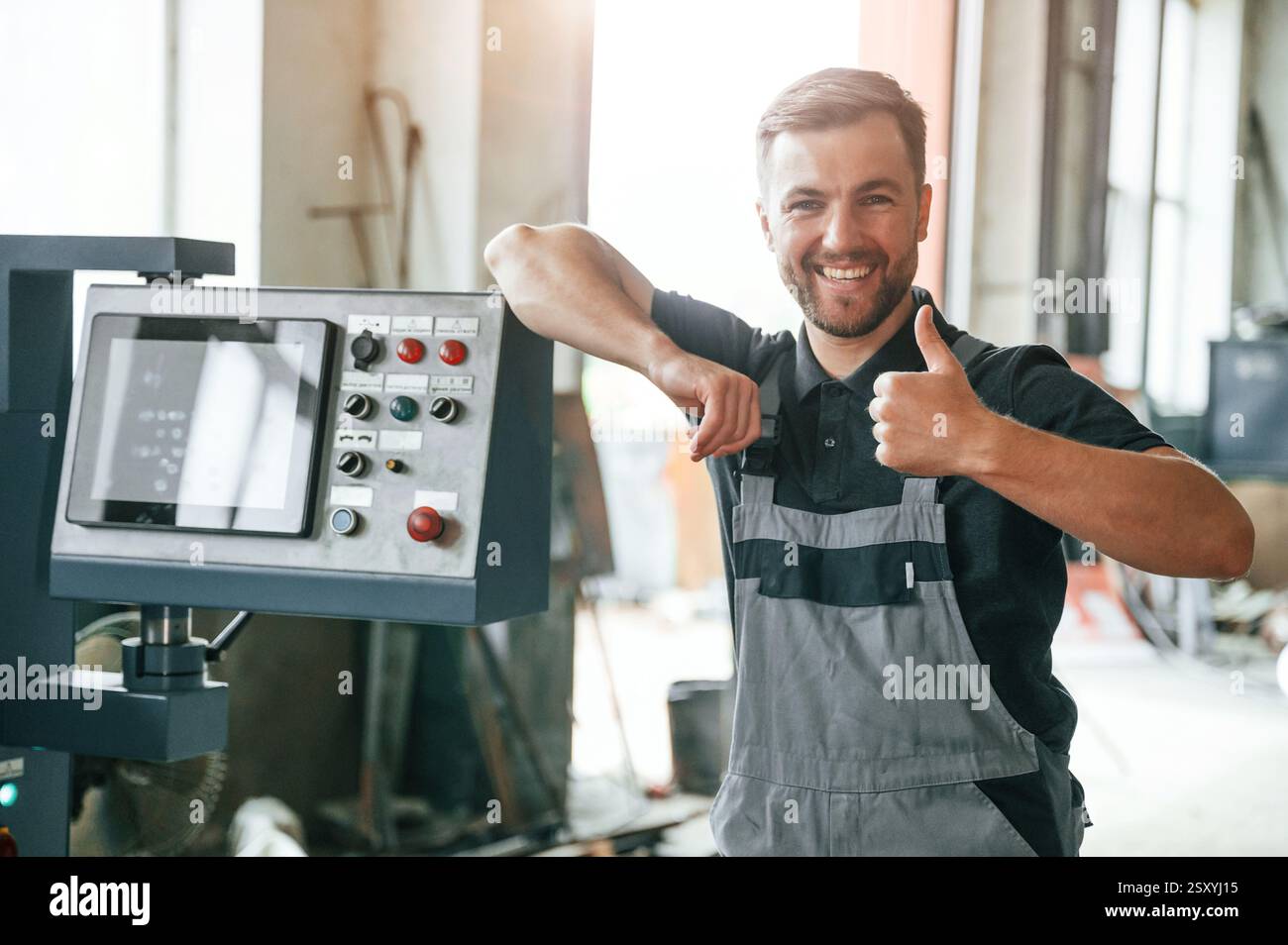 Standing near operate device. Man in uniform is in workstation ...