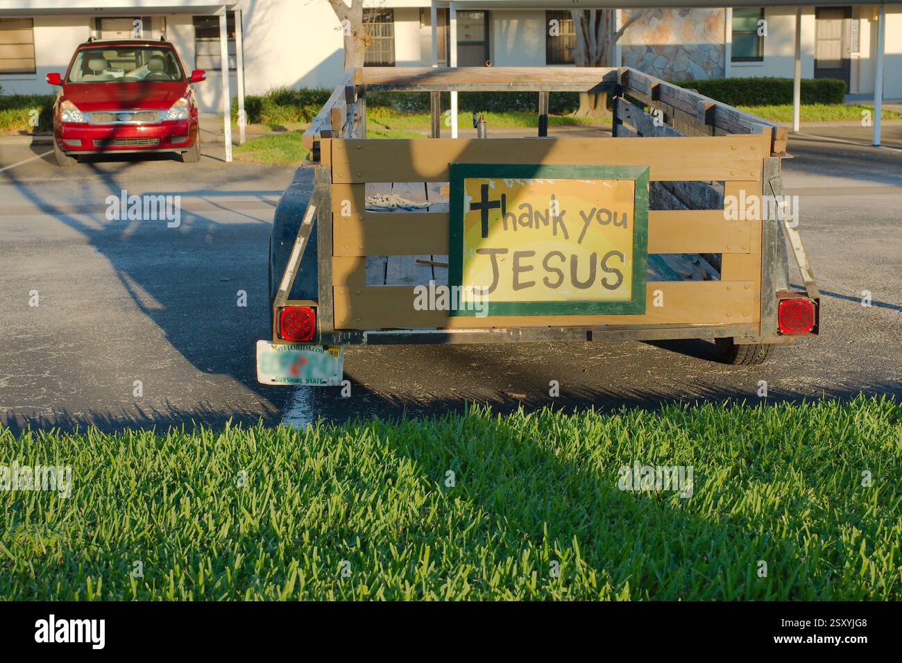 Wide rear view back of wood trailer in a parking lot. Green and Yellow ...