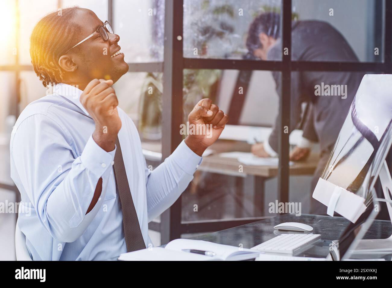 happy man working in the office. raised his hands joyfully Stock Photo ...