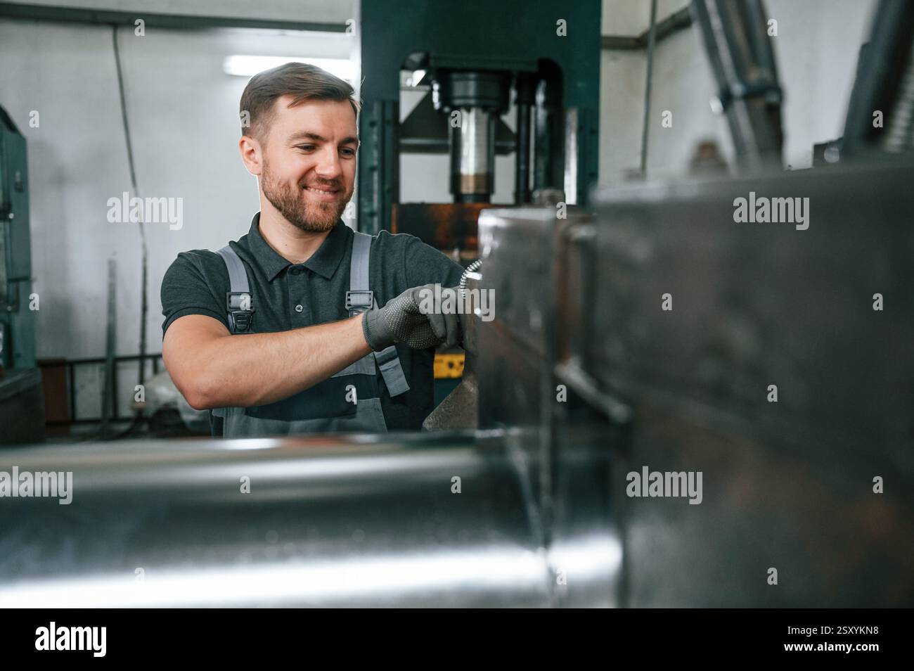 Professional engineer operating machine. Man in uniform is in ...