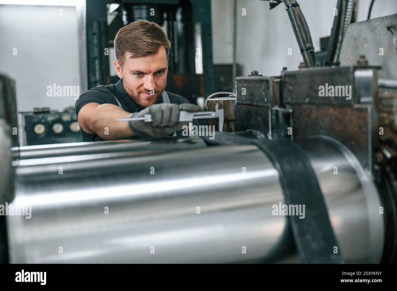 Using measure tool. Man in uniform is in workstation developing details ...