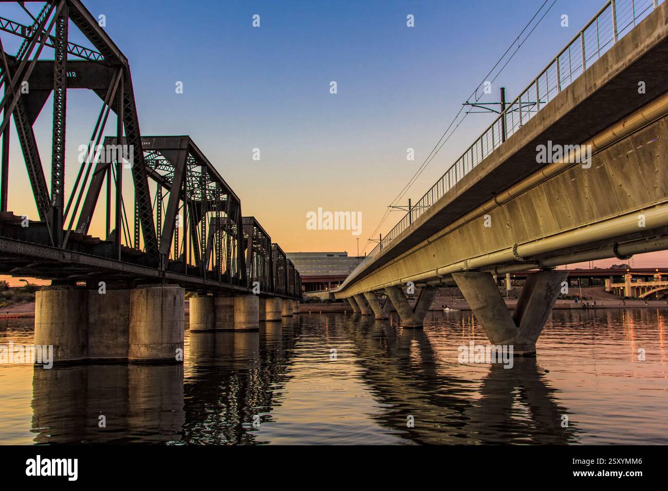 Bridge over a river with a train crossing it. The bridge is made of ...