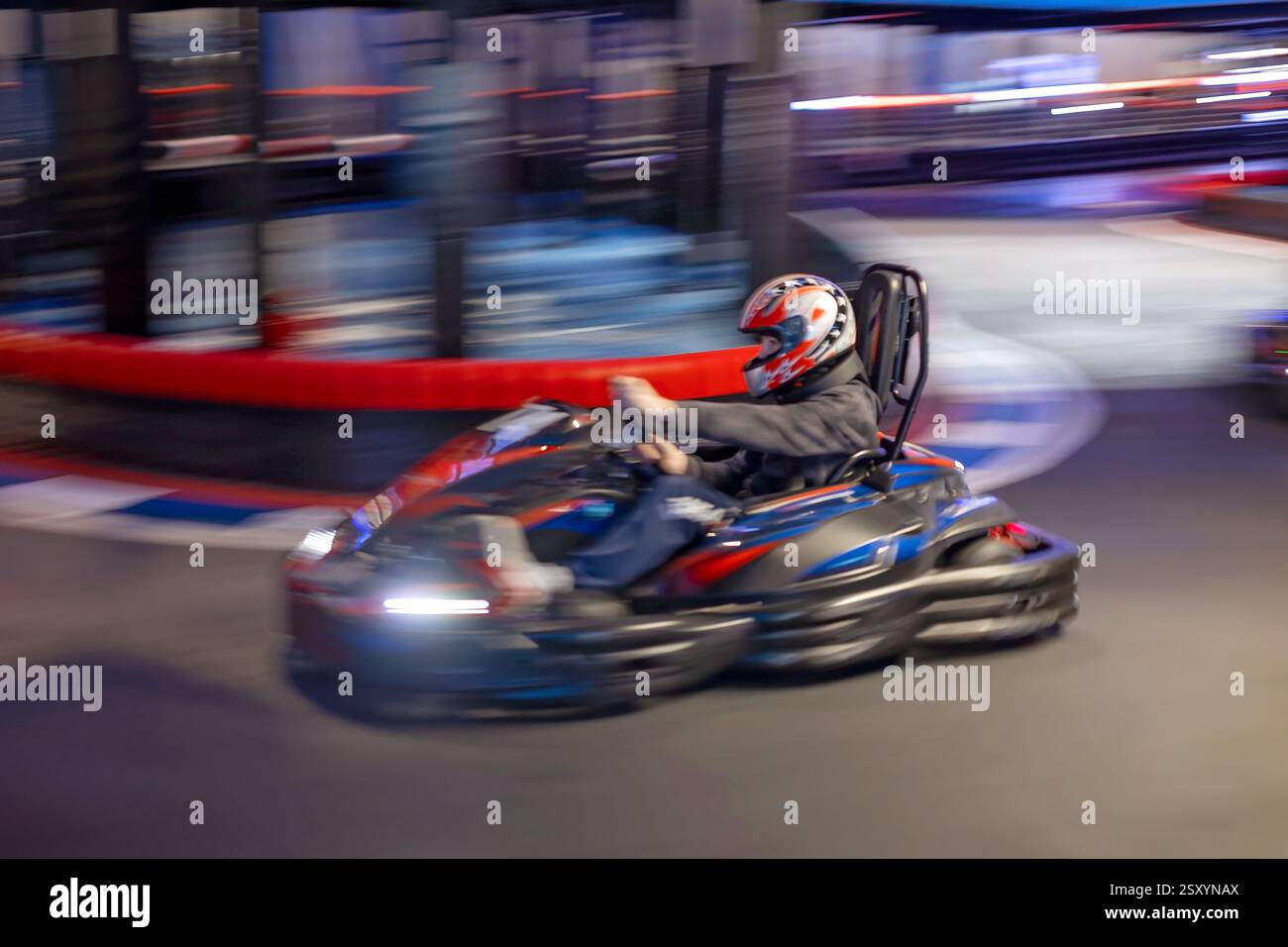 Child, driving go cart car in an indoor race track, enjoying sport ...