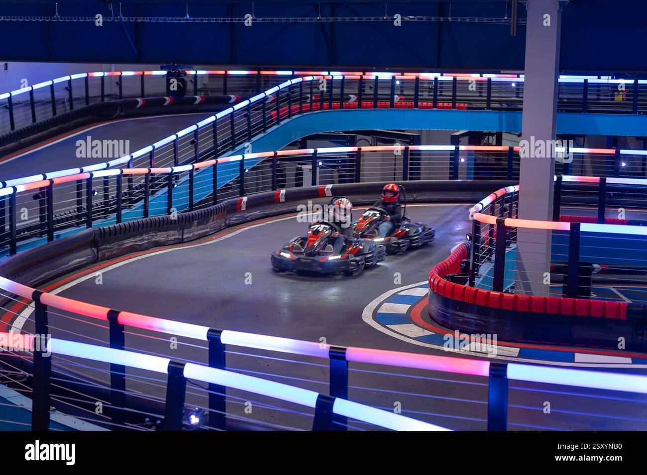 Child, driving go cart car in an indoor race track, enjoying sport ...