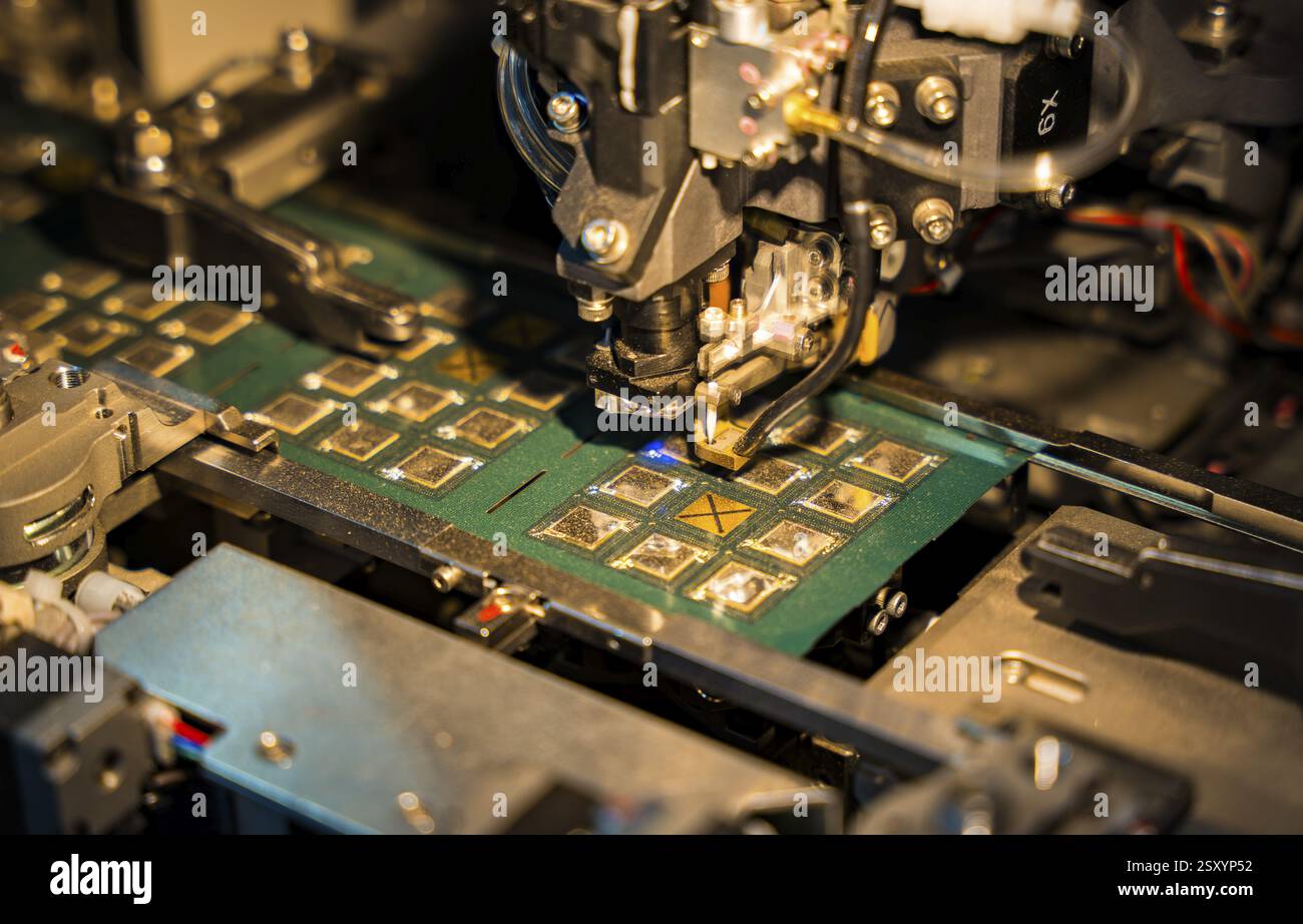 Robotic machine manufacturing semiconductor computer ship at a stall to ...