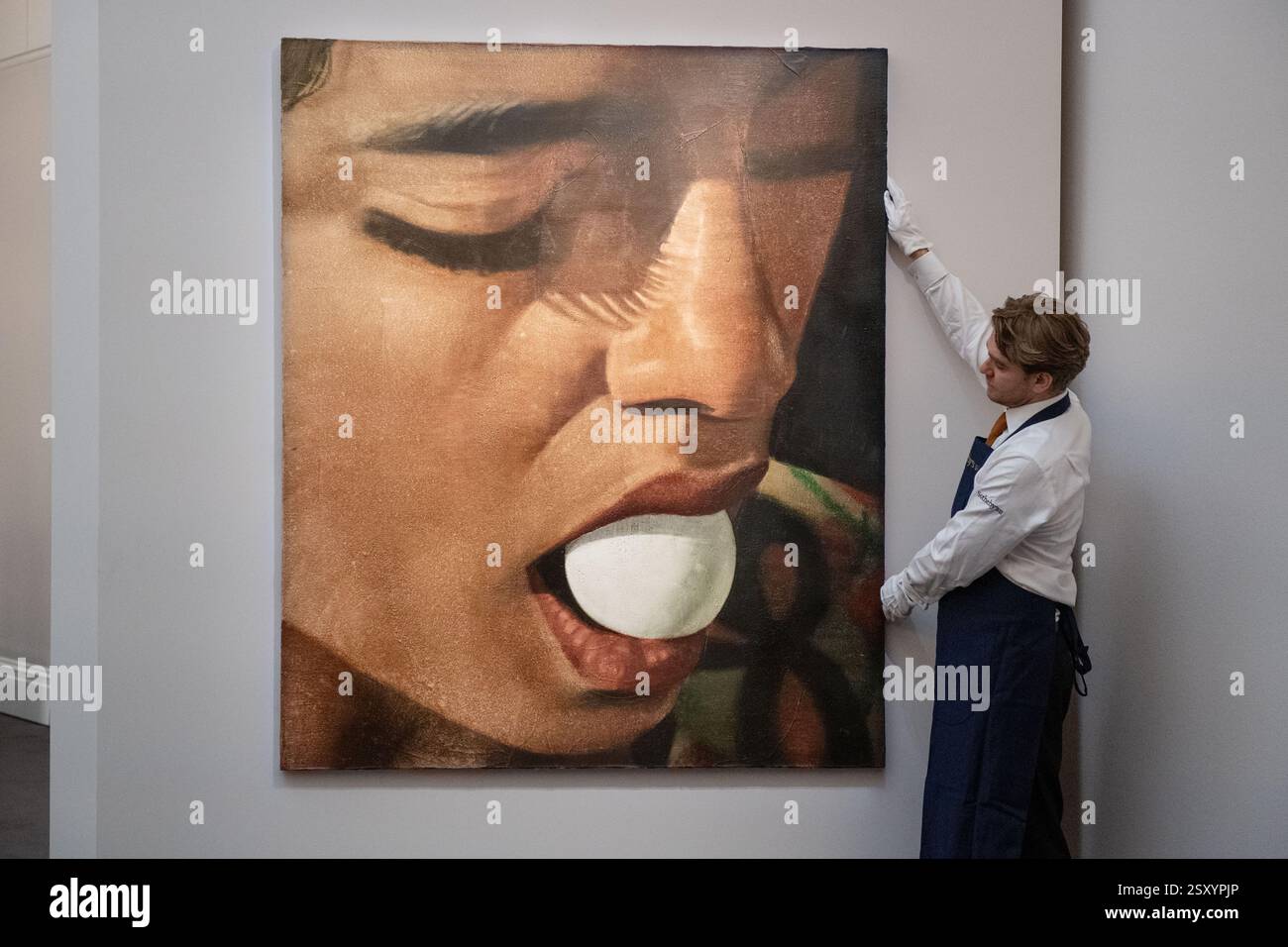 London, England, UK. 26th Feb, 2025. A Sothebys staff member holds 'Silent Treatment' by Joseph ...