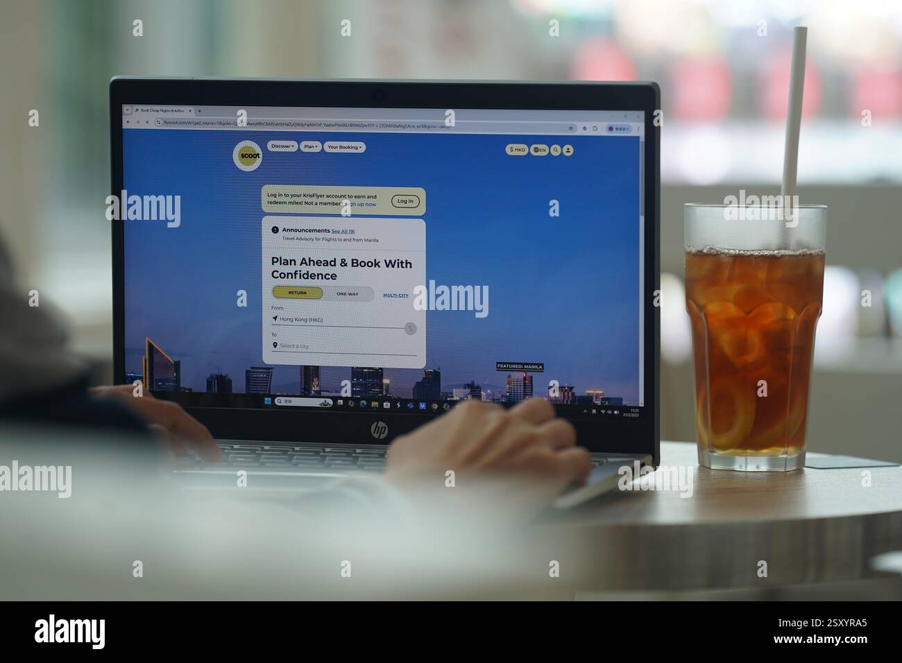 In this photo illustration, A woman browses Flyscoot website on her laptop (Photo by Serene Lee ...