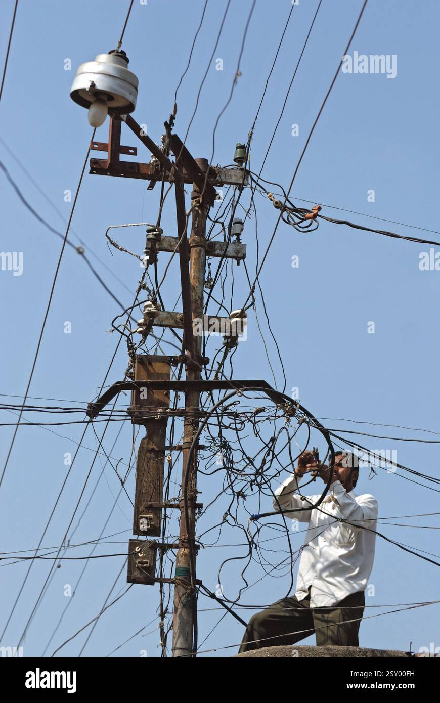 Electrician working on high tension electric wire, Malegaon ...