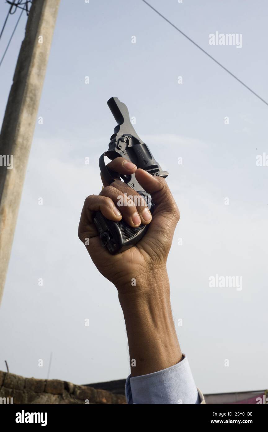 Revolver pistol in hand India Asia Stock Photo - Alamy