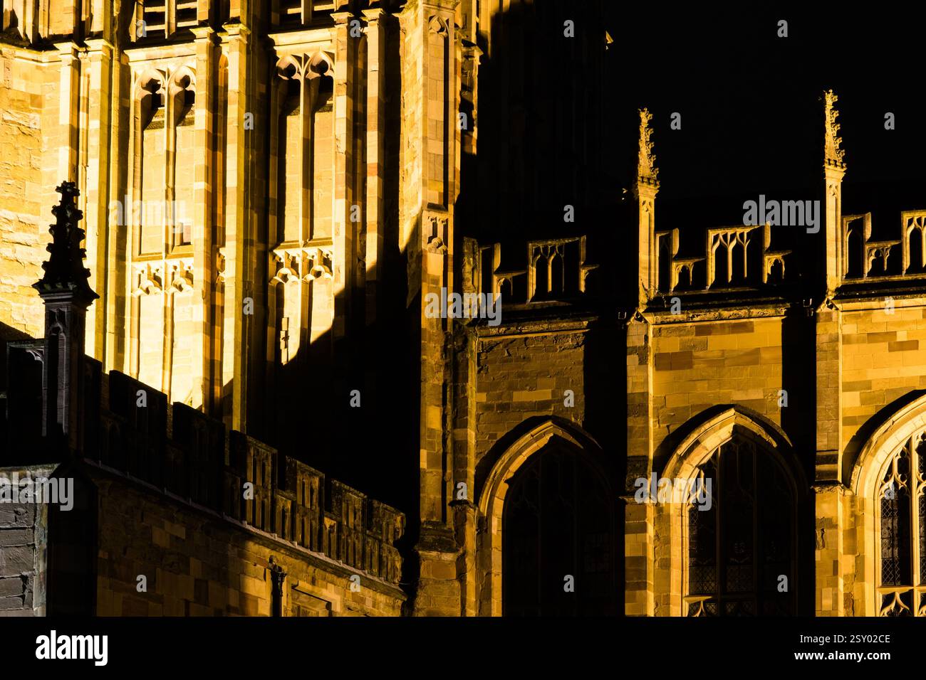 Medieval church illuminated at night, featuring stone sculptures and ...