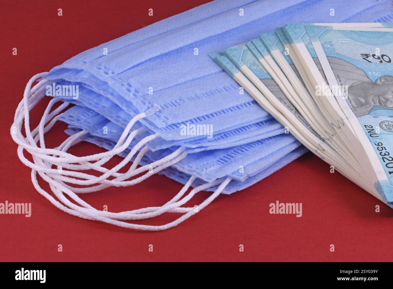 Surgical masks and indian money, bank notes and pilles of surgical mask ...