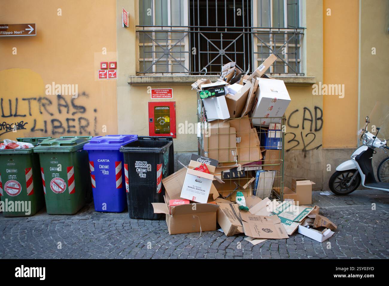Overflowing recycling bins with garbage scattered around, illustrating ...