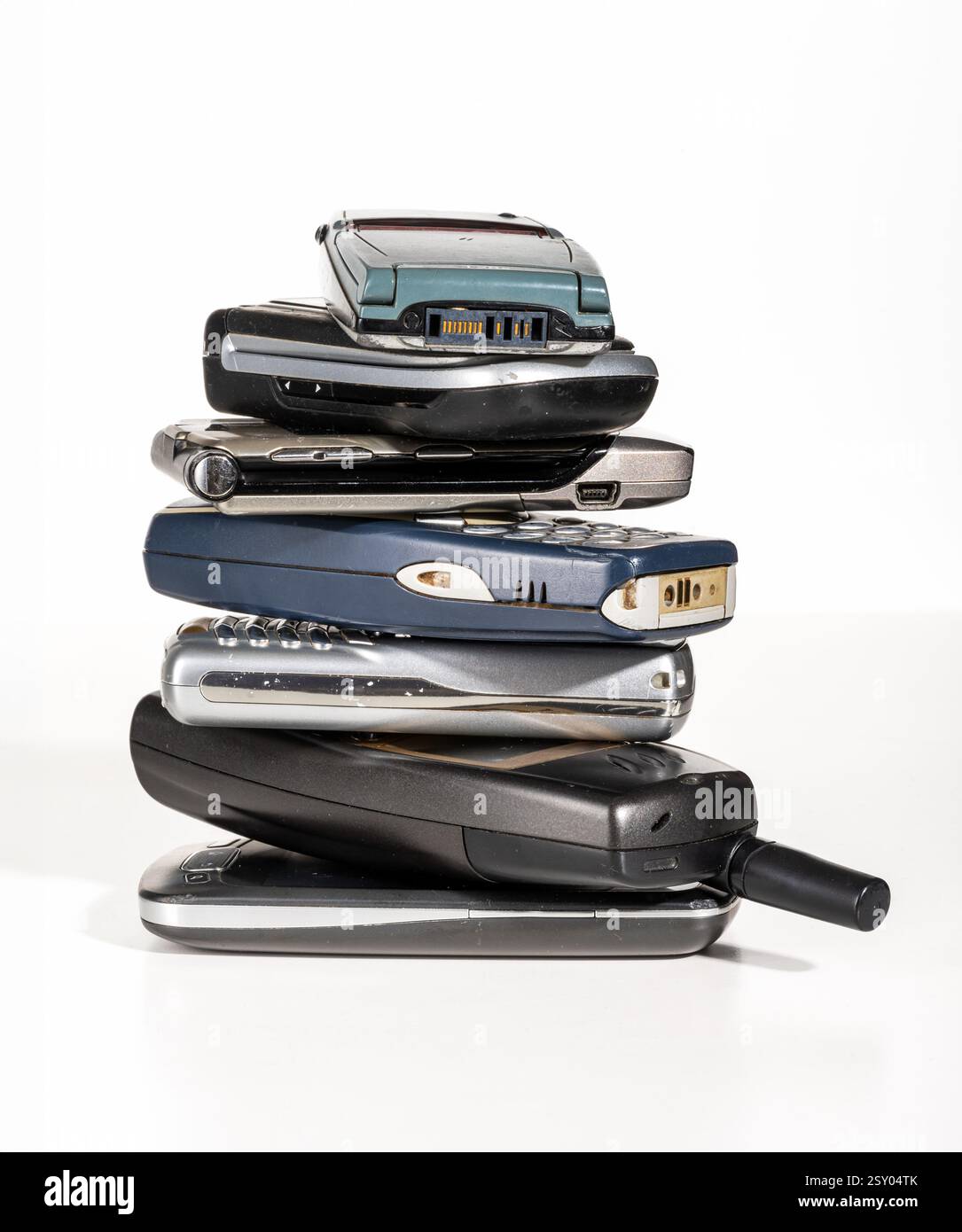 Isolated stack of old cell phones representing the rapid technological ...