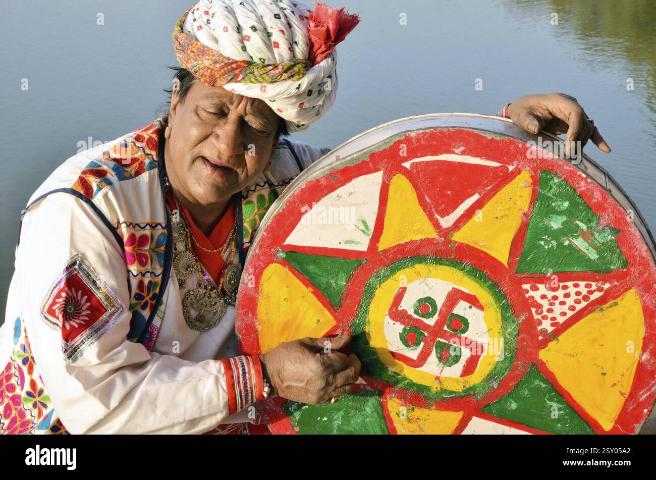 Folk singer playing musical instrument Gadisar Lake Rajasthan India ...
