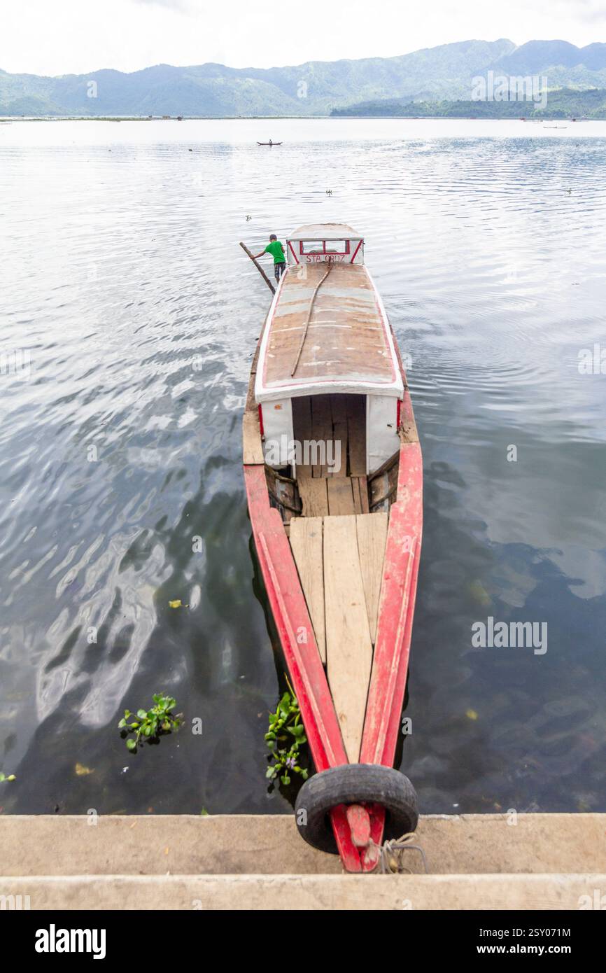 A banca is being docked at the edge of Lake Buhi in Bicol, Philippines ...