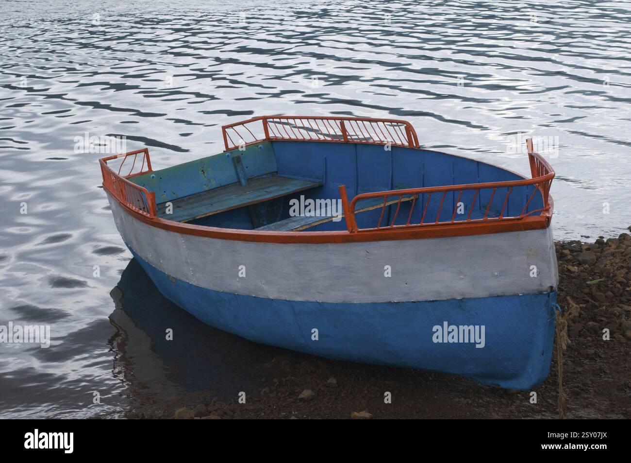 Rowing boat anchored shore of Shiv Sagar lake Tapola Maharashtra India ...