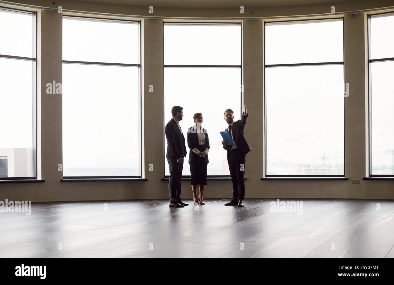 Man realtor agent showing modern office space for a rent to business ...