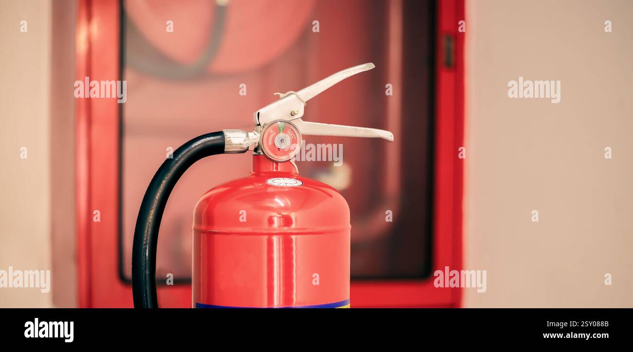 The red fire extinguisher is ready for use in case of an indoor fire ...