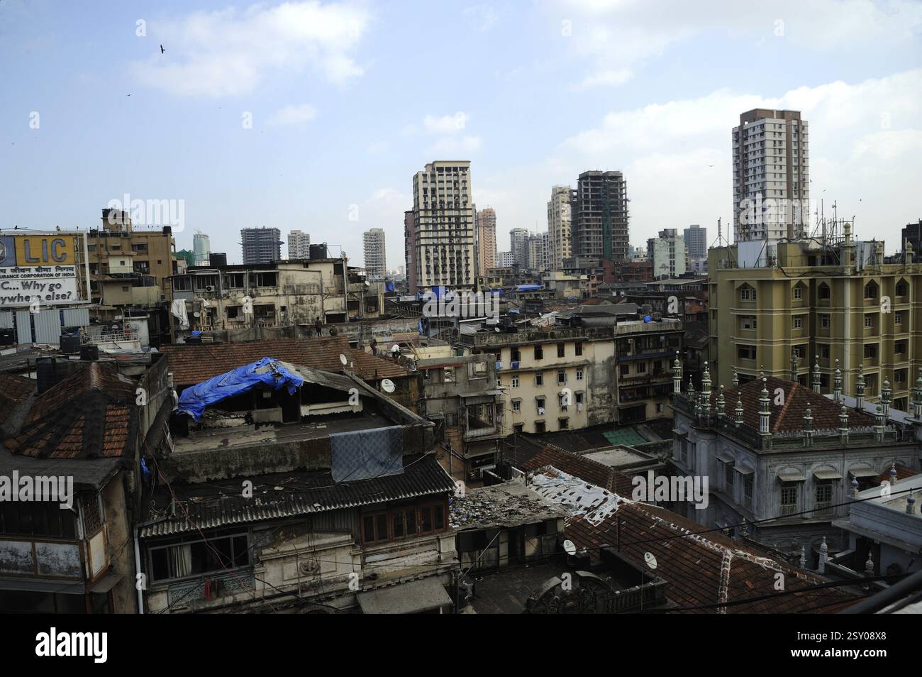 Old mud roof houses and new modern towers, mumbai, maharashtra, India ...
