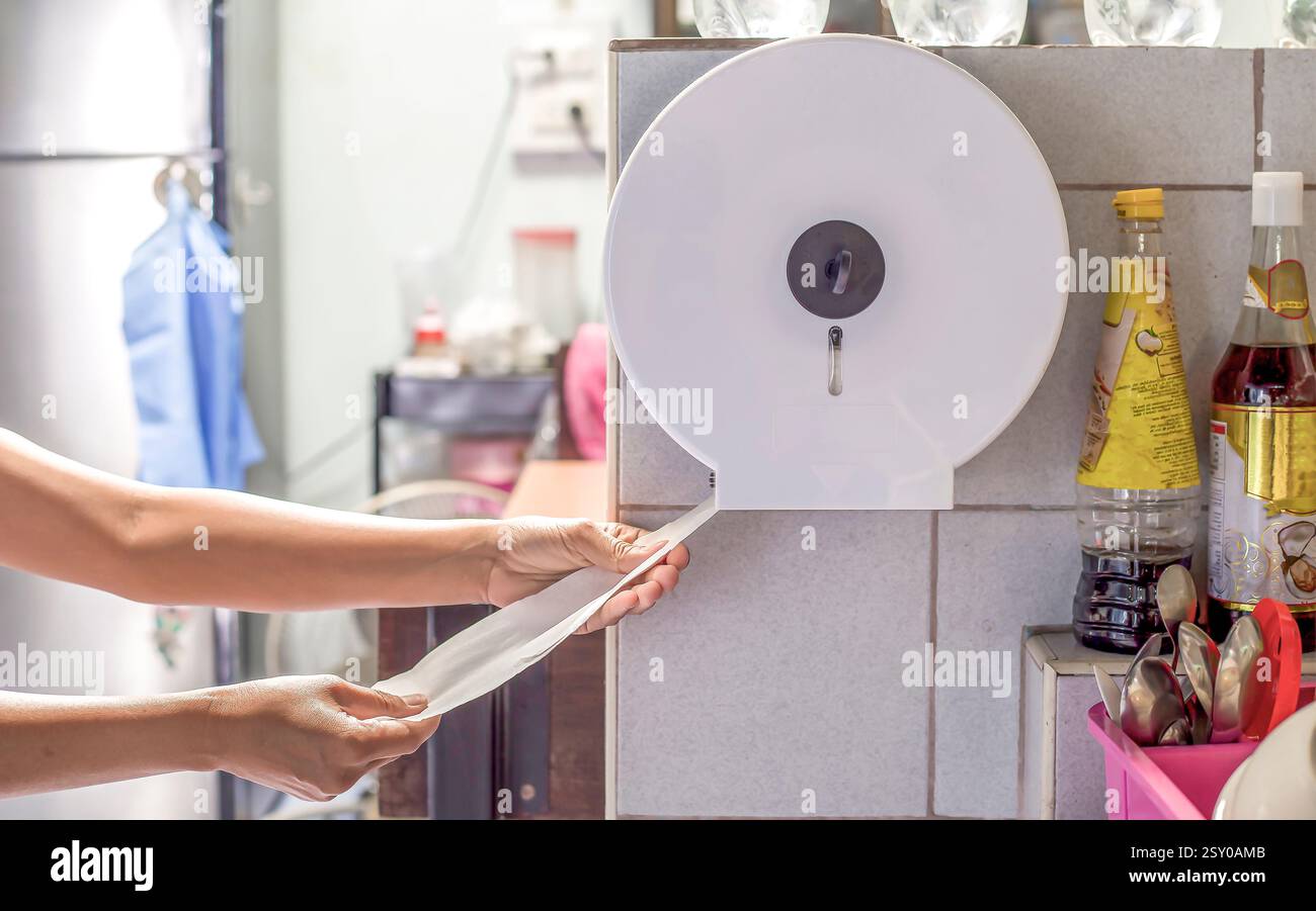 The maid was pulling the tissue paper by hand for cleaning Stock Photo ...