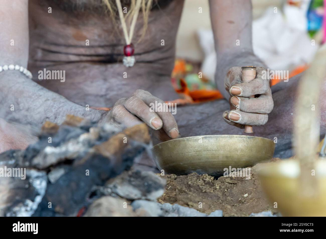 spiritual naga sadhu holding marijuana pipe in hand during mahakumbh ...