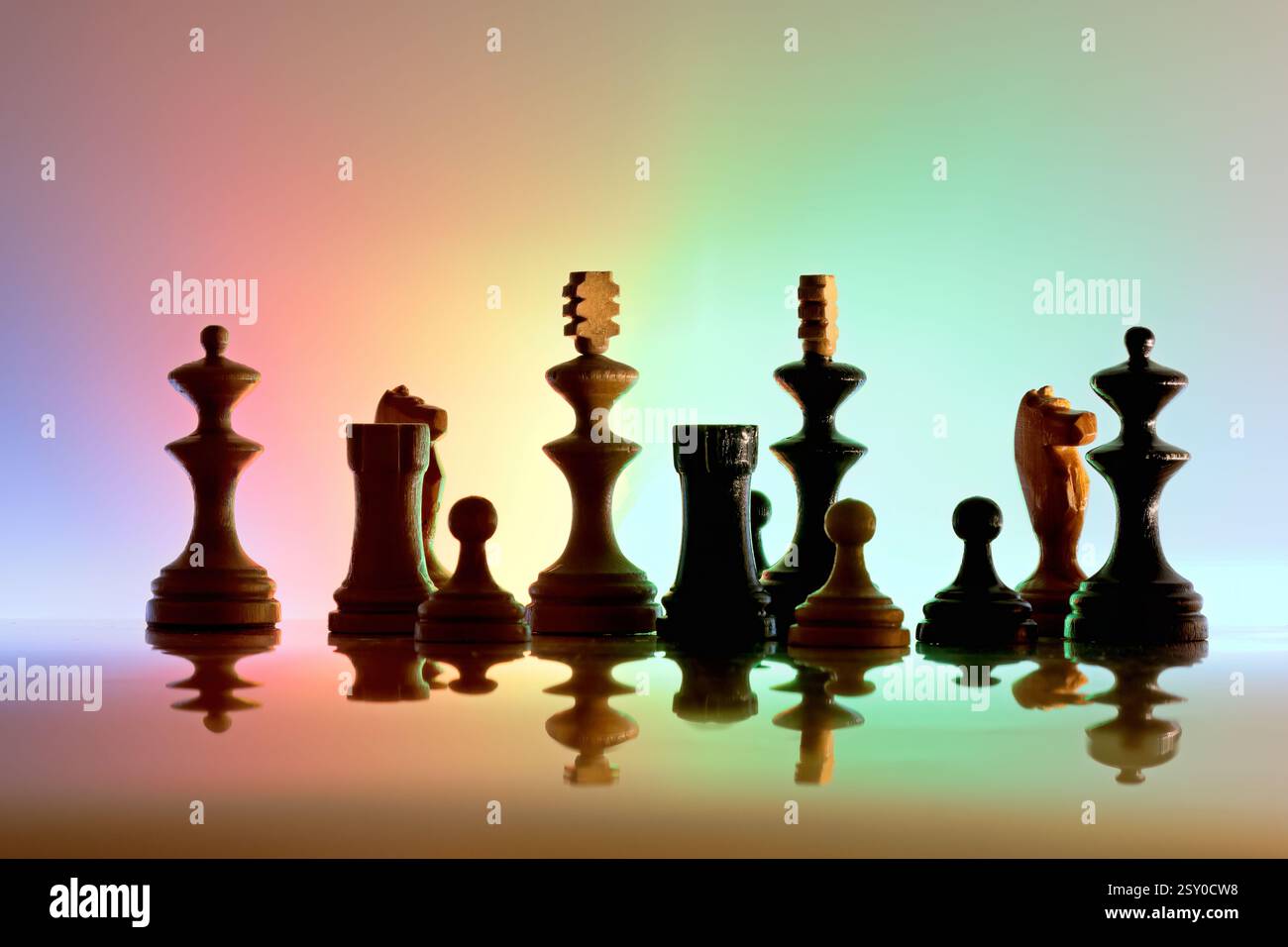 Chess pieces on reflective surface with colorful background Stock Photo ...