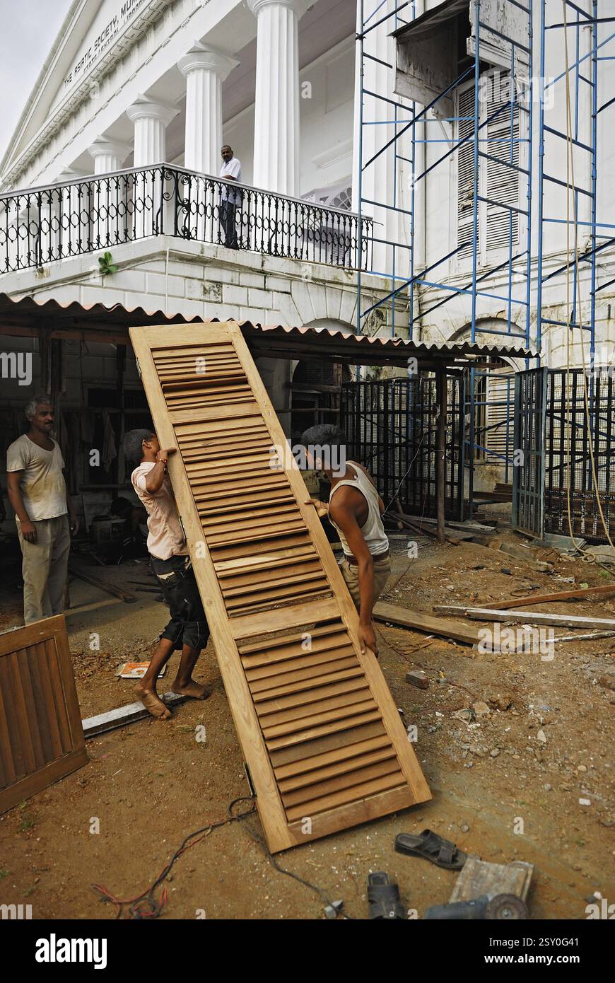 Workers carrying teak wood at Town Hall Bombay Mumbai, Maharashtra ...