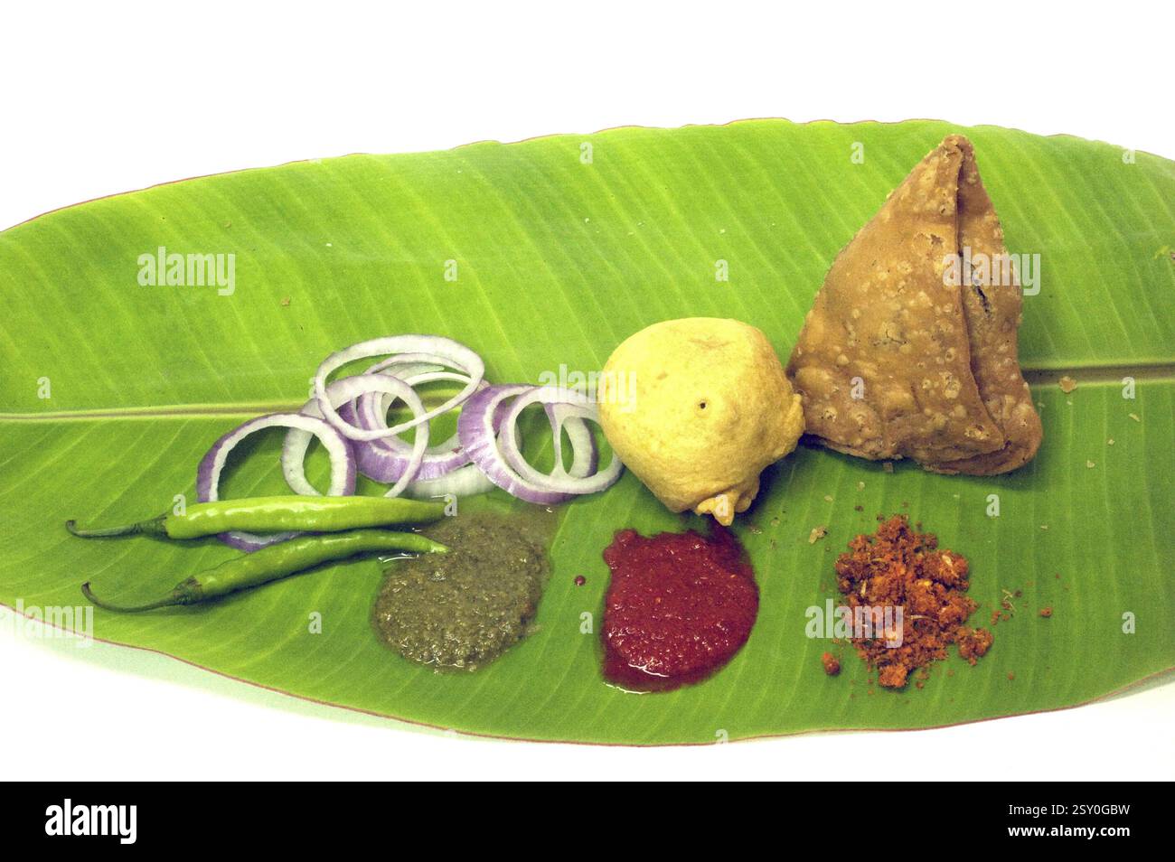 Vada and samosa with chutney on banana leaf mumbai Maharashtra India ...