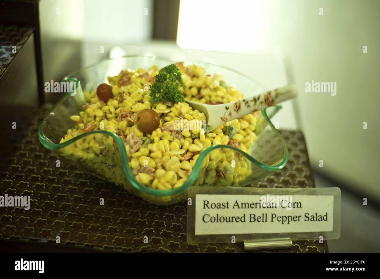 Roast American corn coloured bell pepper salad on buffet table mumbai ...