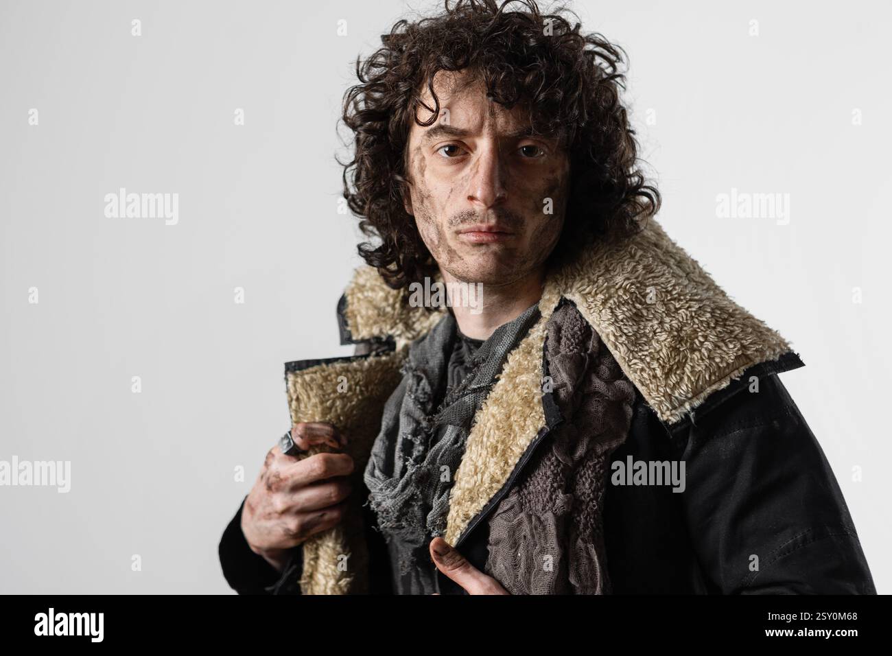 A curly-haired guy in a grunge outfit, a dramatic portrait of a ...