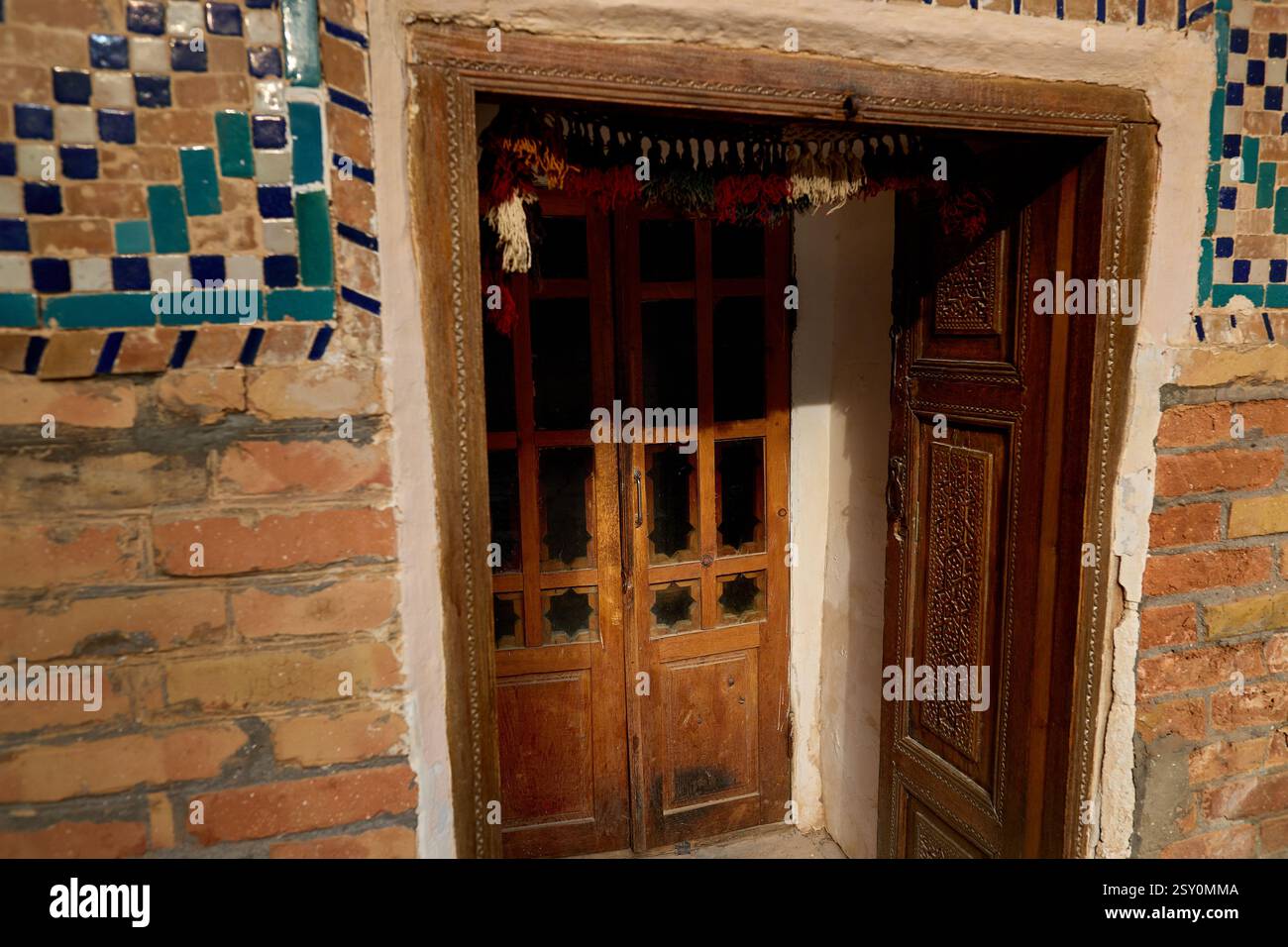 Old wooden door in Beautiful madrassah at Registan old public square ...