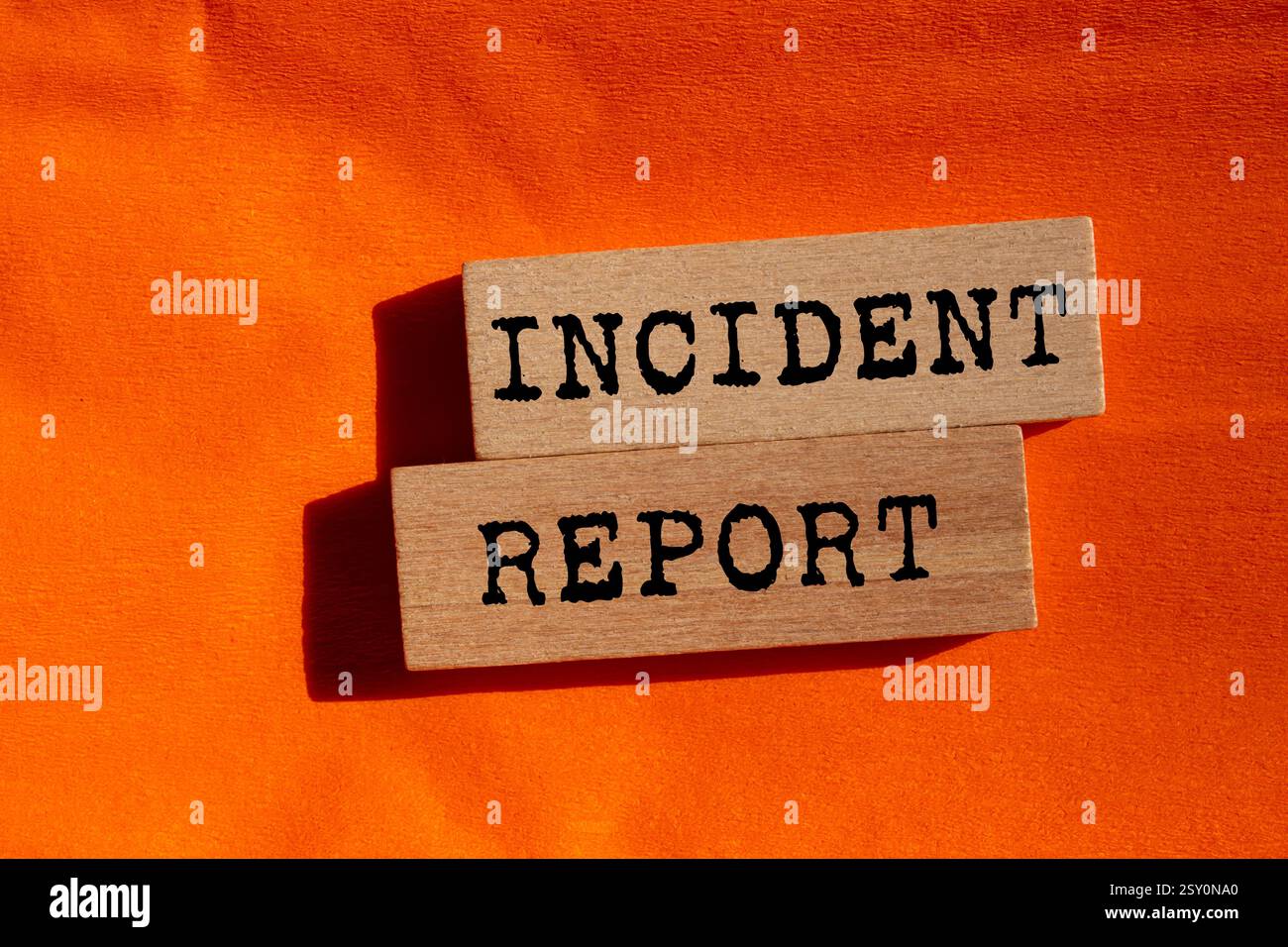 Incident report message written on wooden blocks on orange background ...