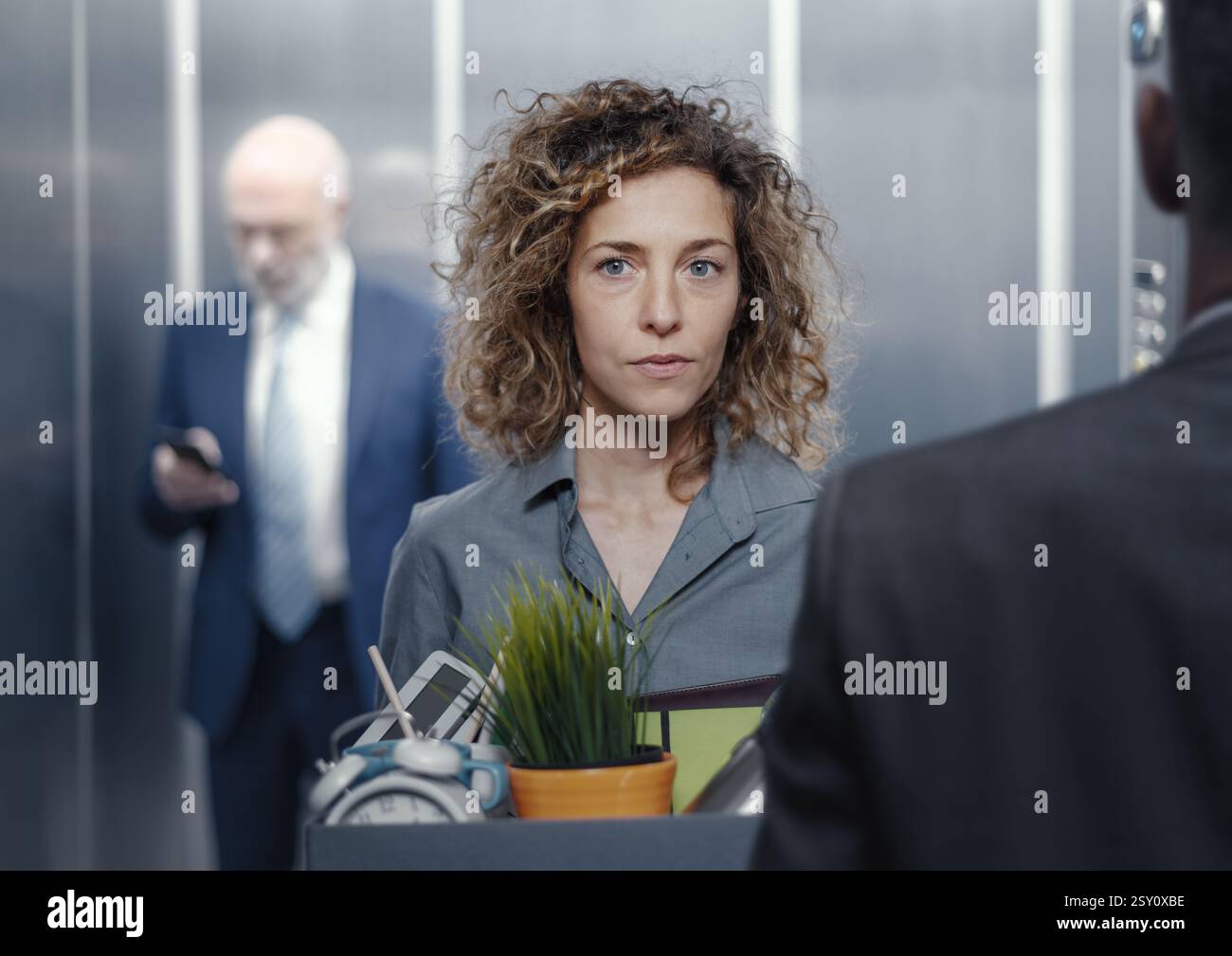 Corporate businesswoman carrying a box with her belongings and getting ...