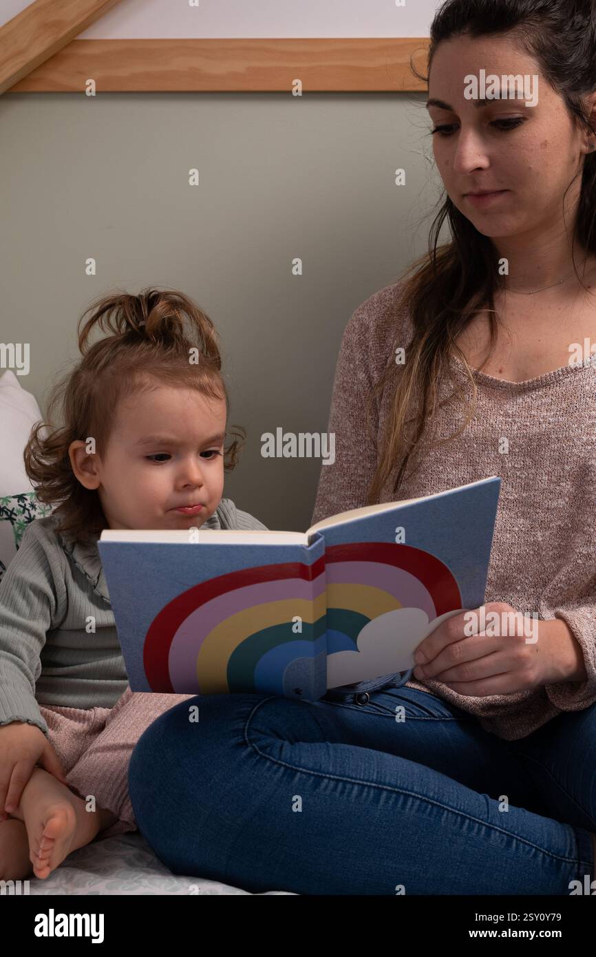 A Special Storytime Moment Between Mom and Daughter Stock Photo - Alamy