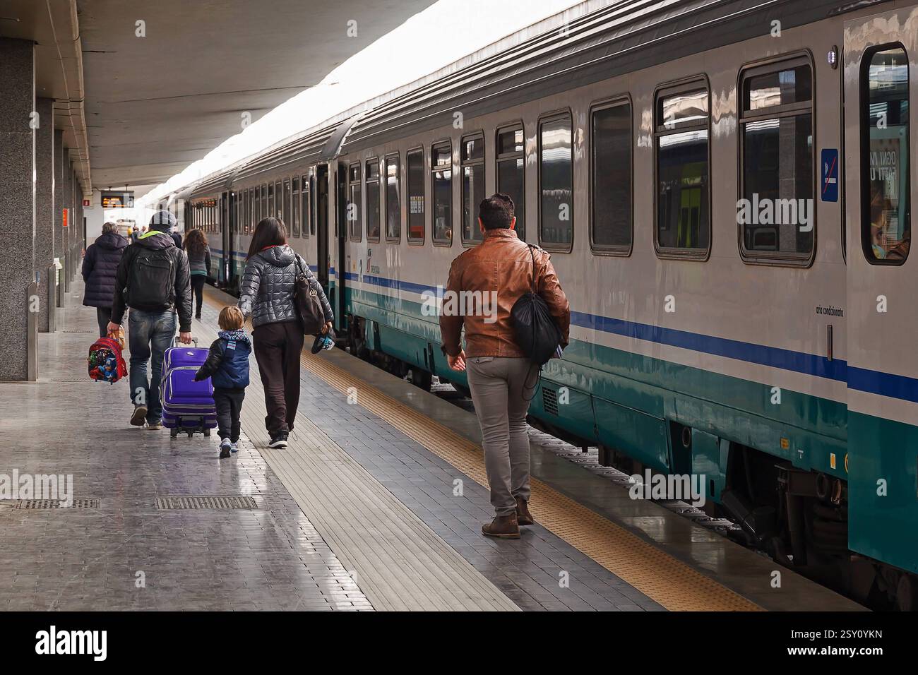Some passengers are going to take the train departing Naples, Italy ...