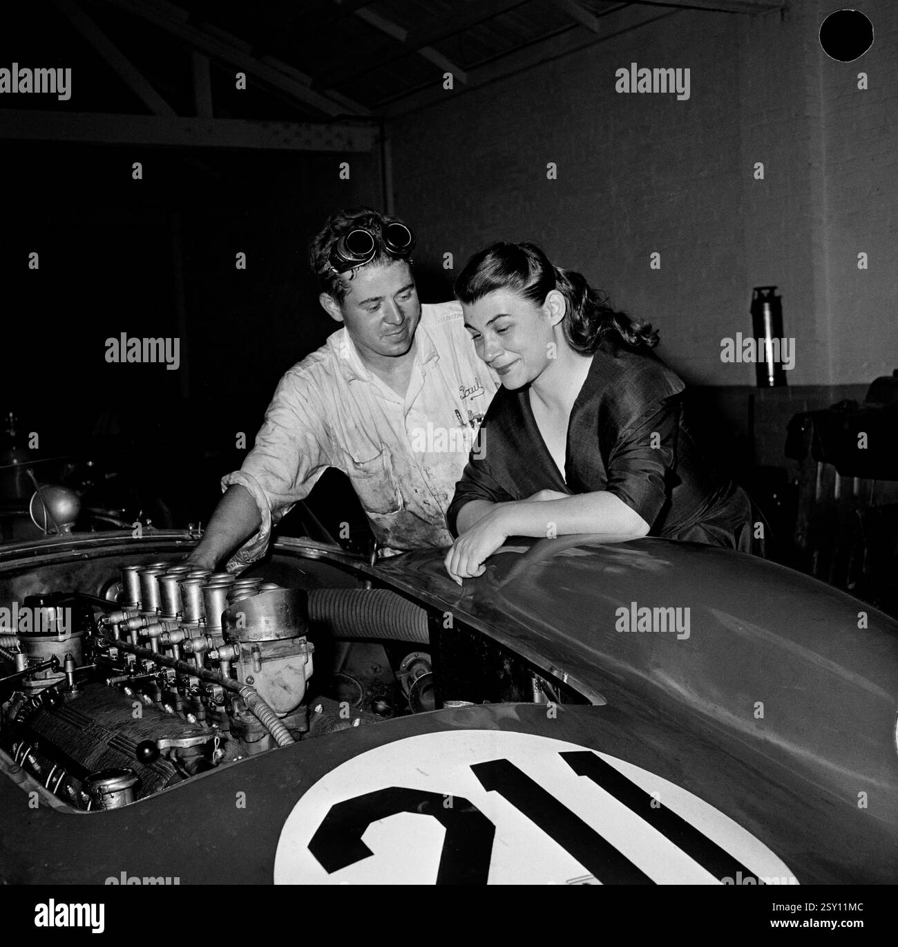 Jose Von Neumann, right, checks over her cars engine with her machanic ...