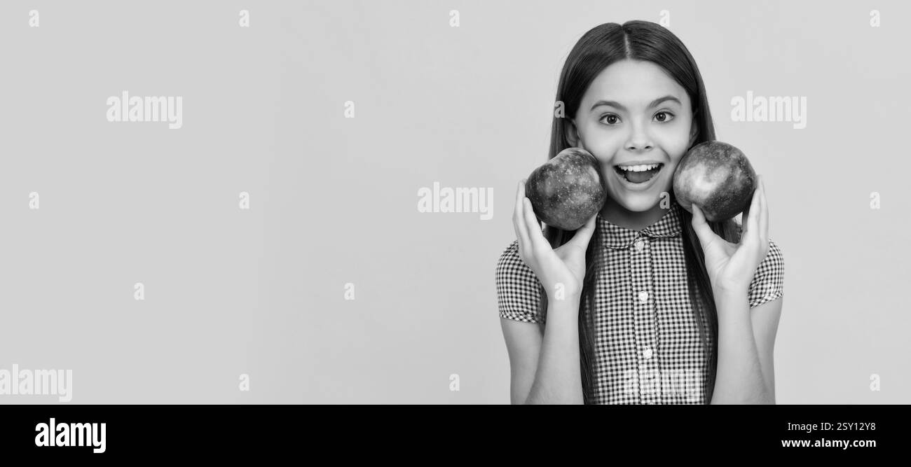 amazed teen girl hold healthy apple fruit. Child girl portrait with ...
