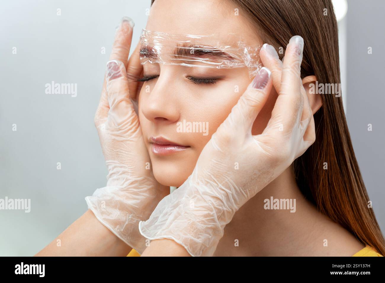 The make-up artist does Long-lasting styling of the eyebrows of the ...