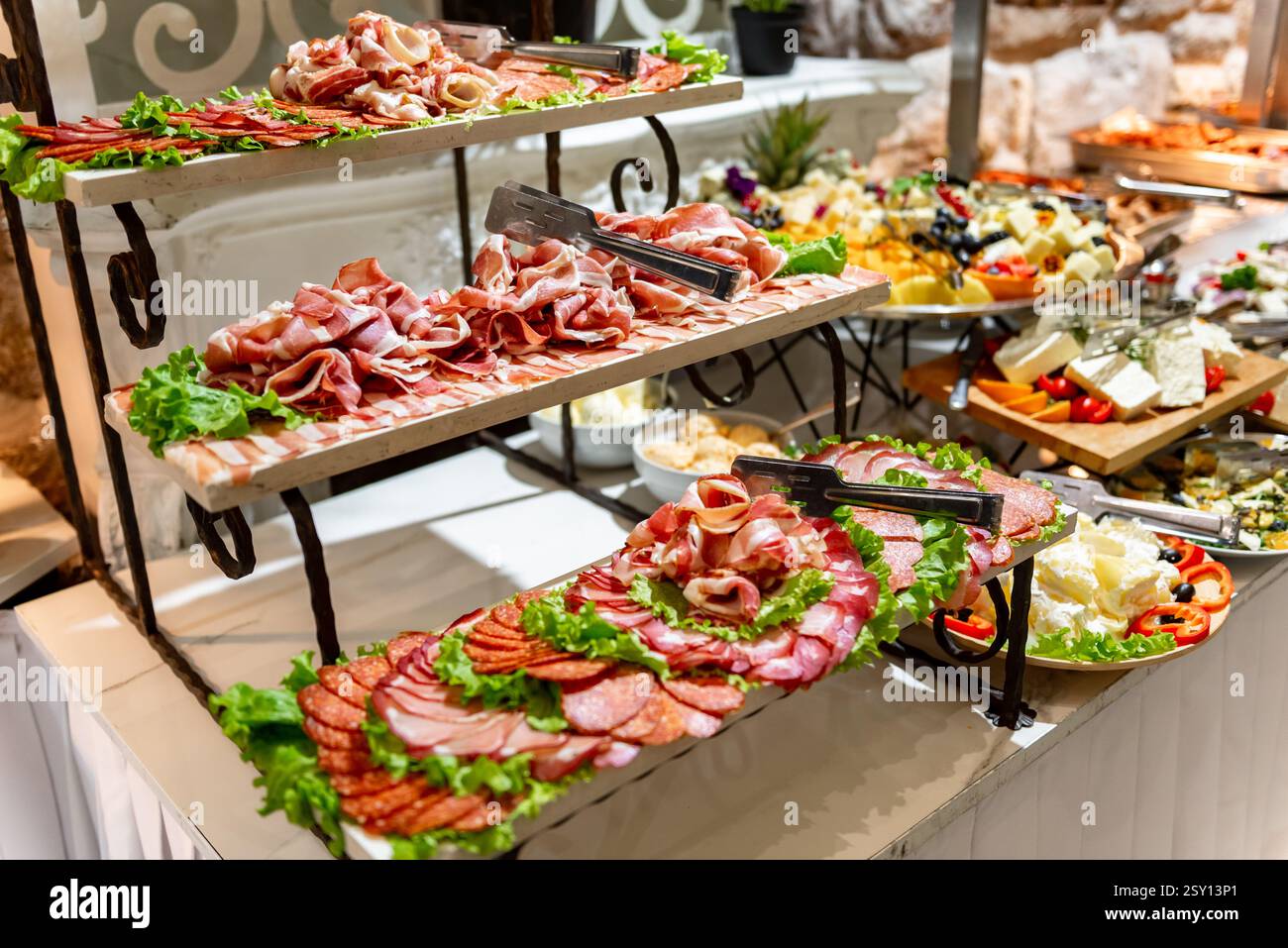 A vibrant display of various deli meats elegantly layered with fresh ...