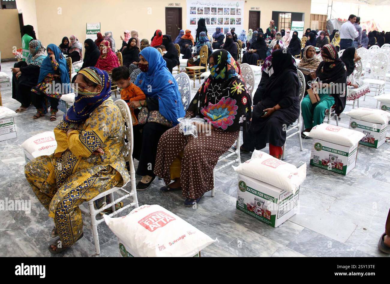 Relief goods is being distributed among needy persons during food aids ...